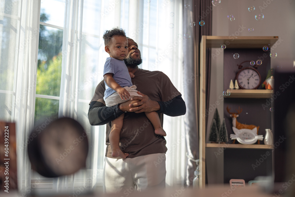The father embraced and carefully picked up his young son with ...