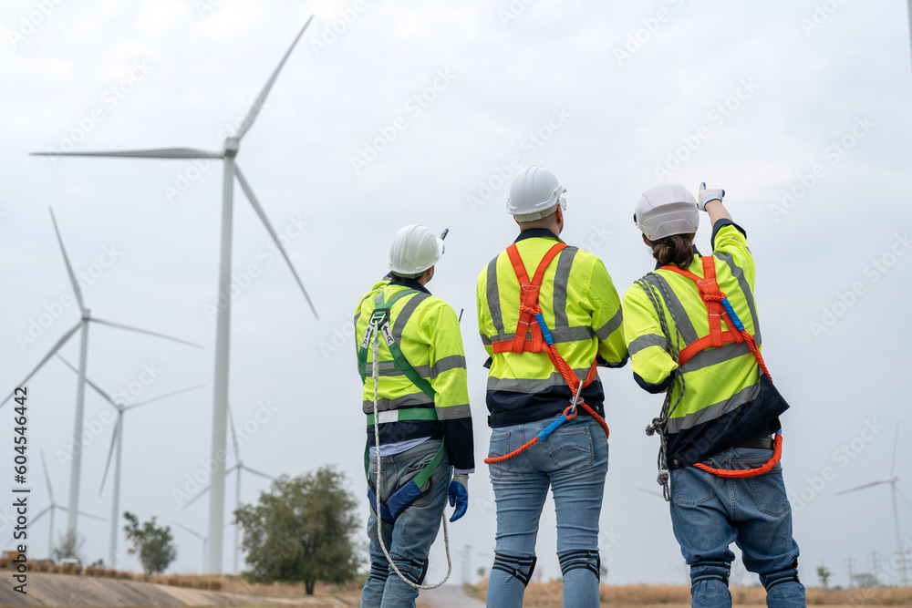 Engineers windmill team wearing uniform and helmet discussing ...