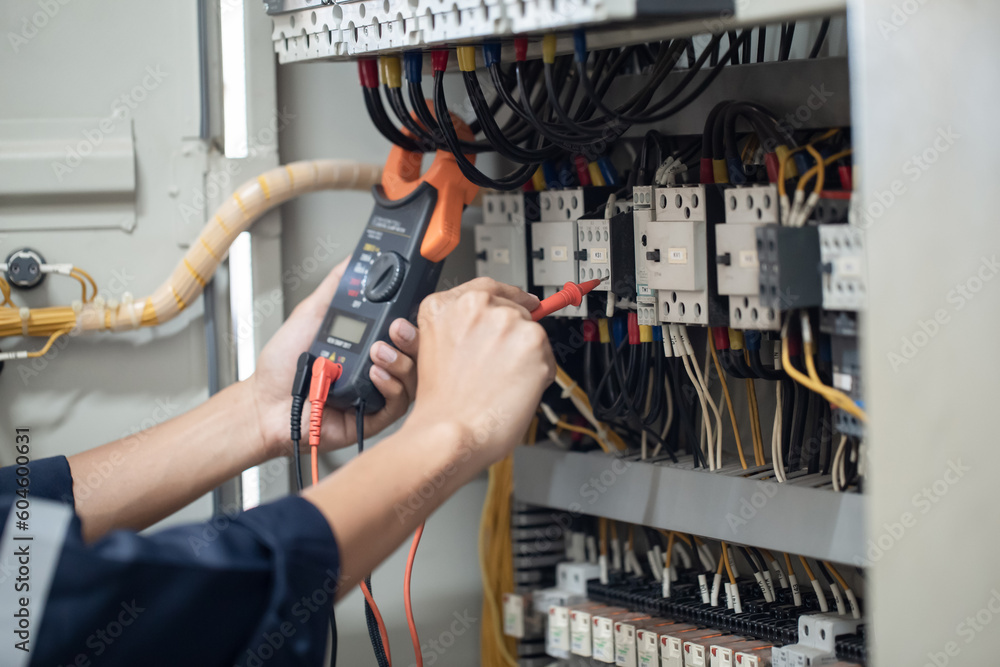 Electrician engineer work tester measuring voltage and current of power ...