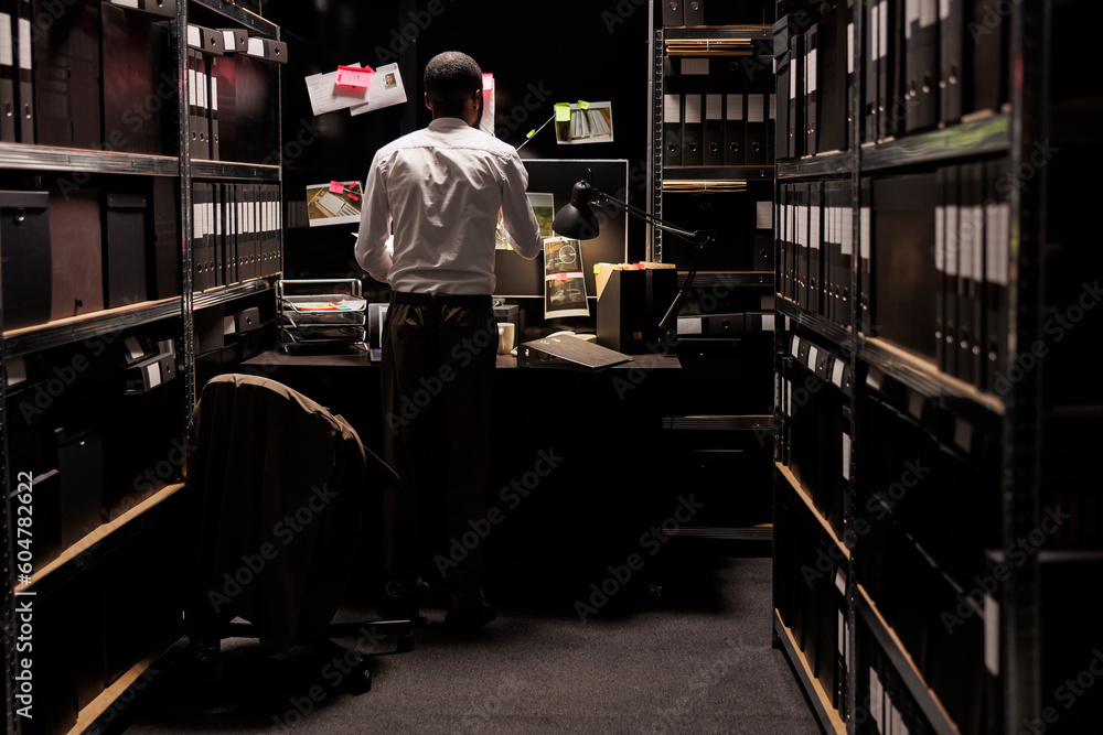 Investigator analyzing detective board, brainstorming to solve crime ...