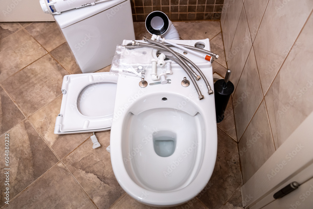 Installing a new toilet bowl in the restroom and its accessories ...
