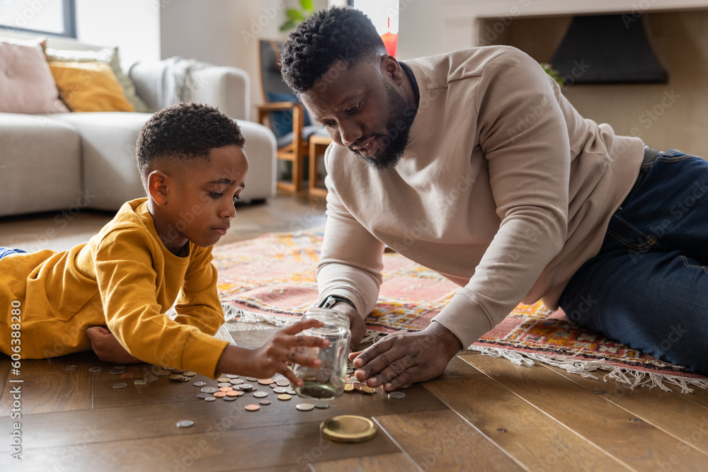 Father and son counting coins saved in an old jar Stock Photo | Adobe Stock