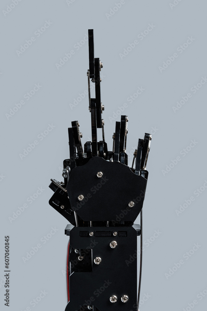 Real robotic hand giving the middle-finger against grey background ...