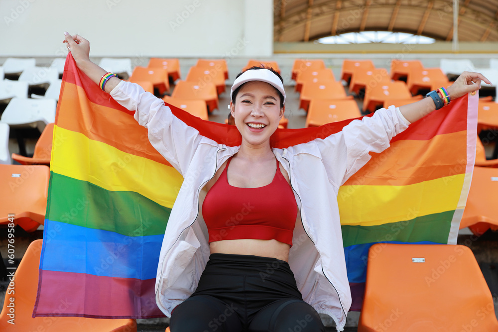 Happy and excited young female asian transgender LGBT sport fan ...