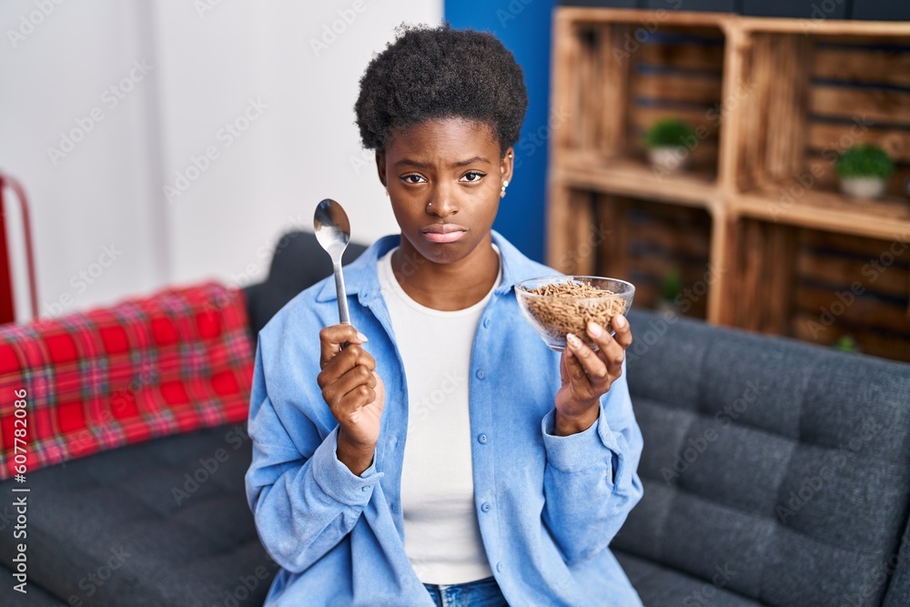 African american woman eating healthy whole grain cereals depressed and ...