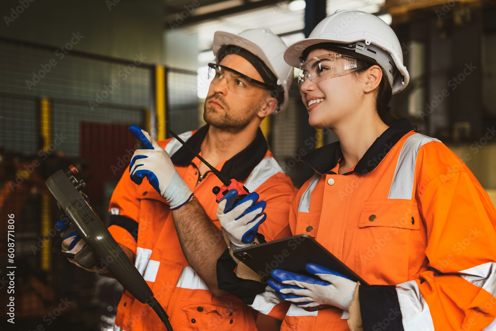 Female engineers holding walkie talkie radios and male programmers in ...