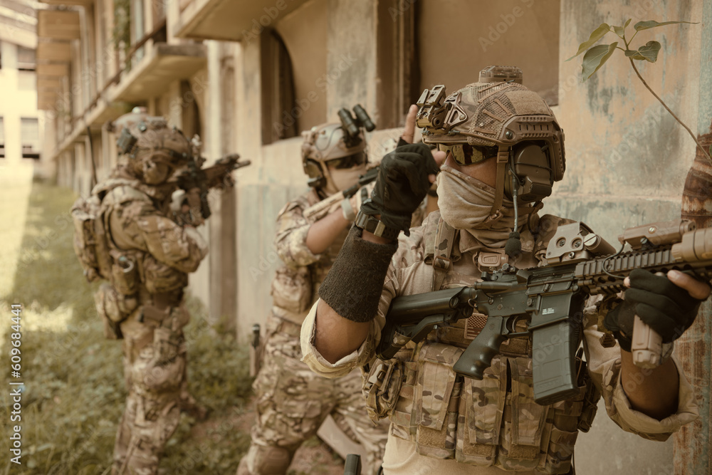 Professional marine soldiers training with weapon on a military range ...
