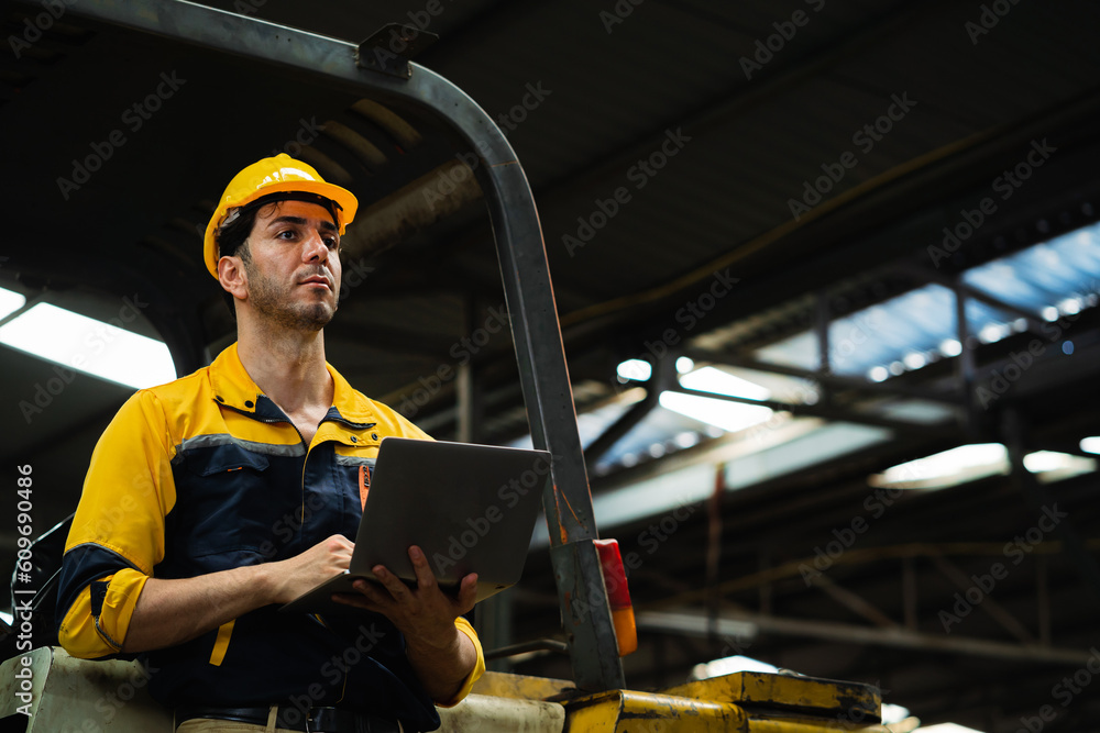 Male forklift driver or worker working in industrial factory or ...