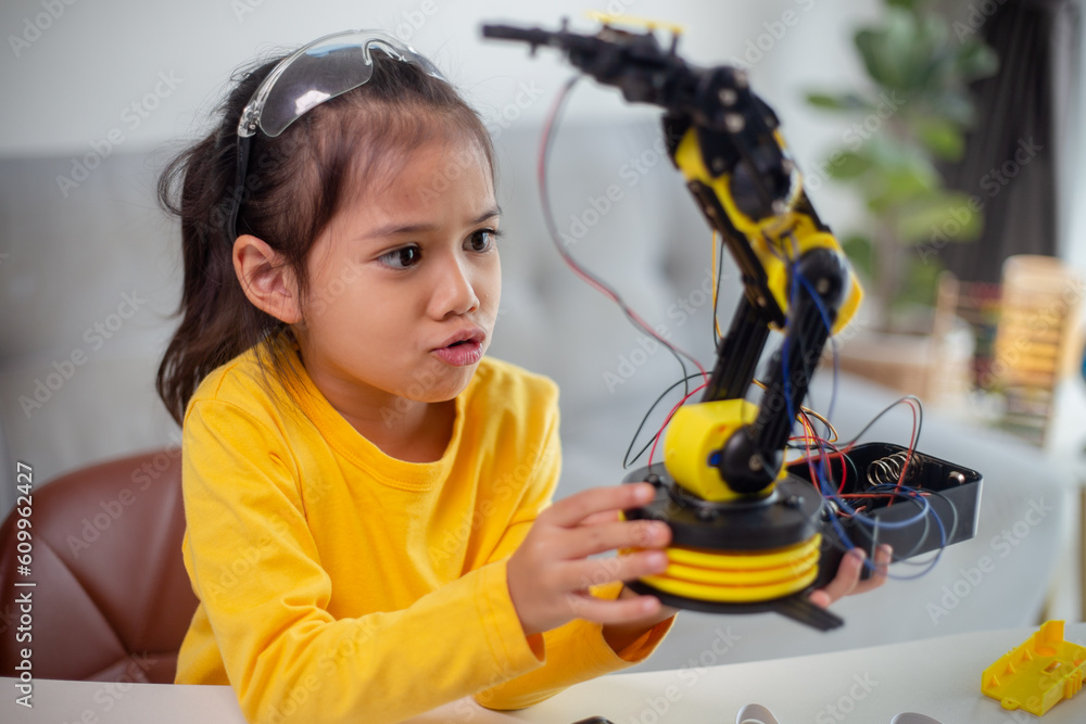 STEM education concept. Asian students learn at home by coding robot arms in STEM, mathematics ...