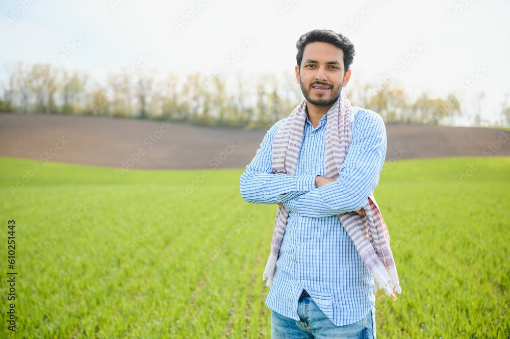 Portrait of young Indian Farmer wearing formal dress in green paddy ...