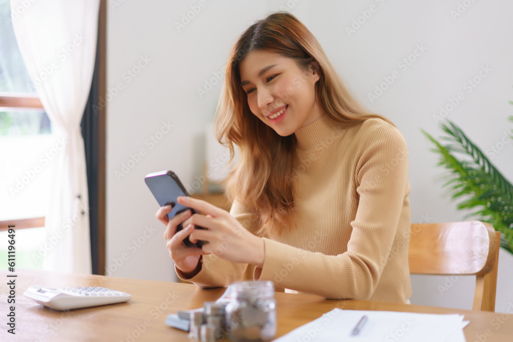 Saving money concept, Asian woman use smartphone and reading data after ...