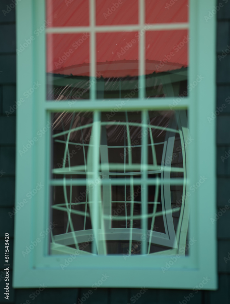 reflection in window of other windows with distortion from glass square ...