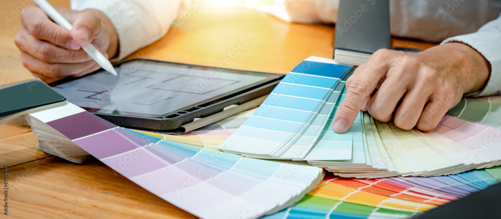 Designer hand choosing and pointing at color swatch or rainbow colour ...