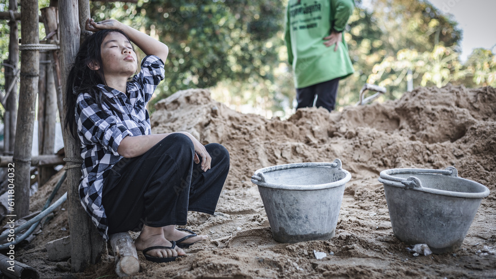 Sad child labor girl relaxing from construction work. World Day Against ...