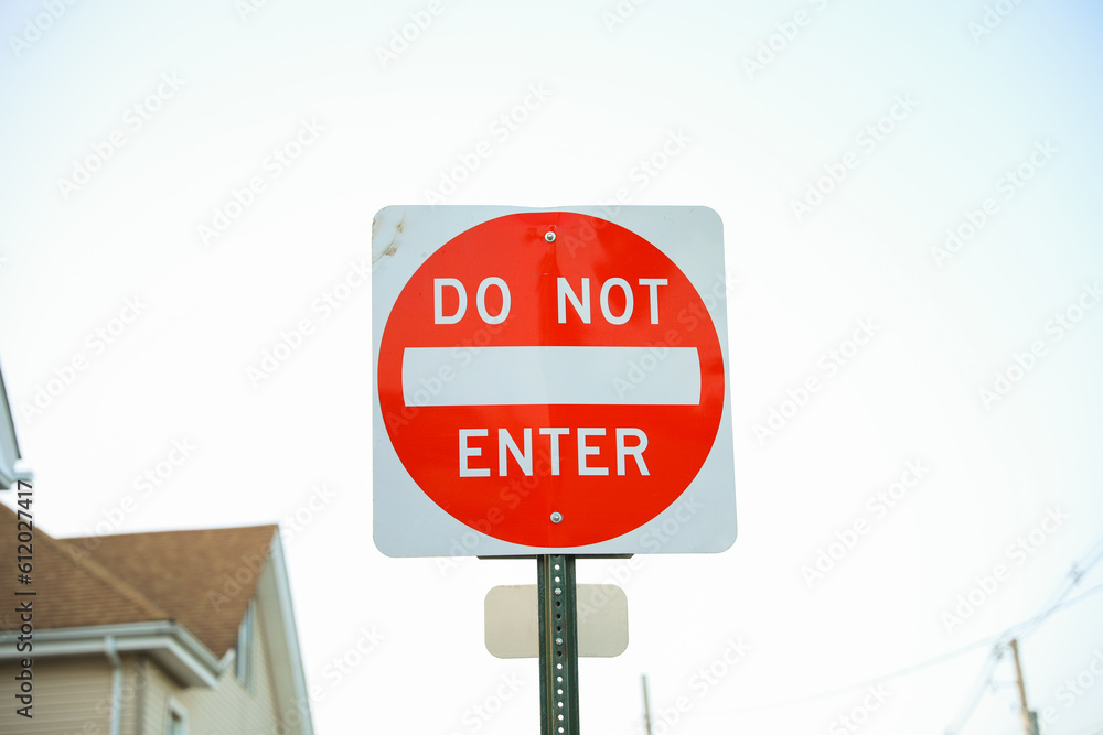 An imposing red 'Do Not Enter' sign stands tall, conveying a powerful ...