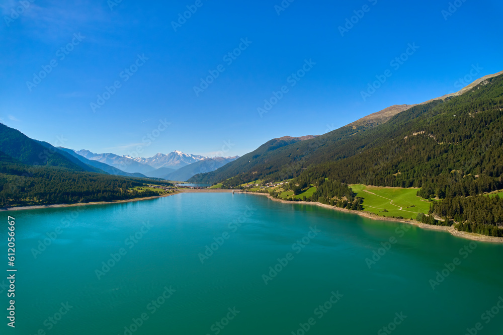 Aerial view of lake (Reschensee). Large reservoir surrounded by ...
