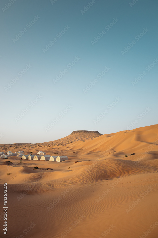 Tent camp in the dunes of the Sahara desert near the Tembaine mountain ...