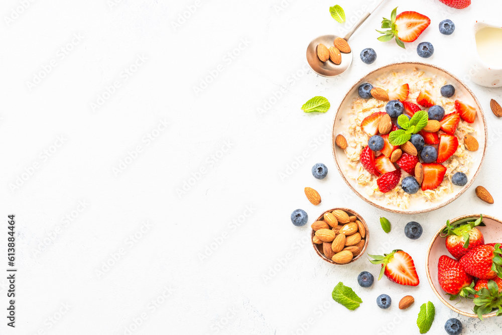 Oatmeal porrige with fresh berries and nuts on white background ...