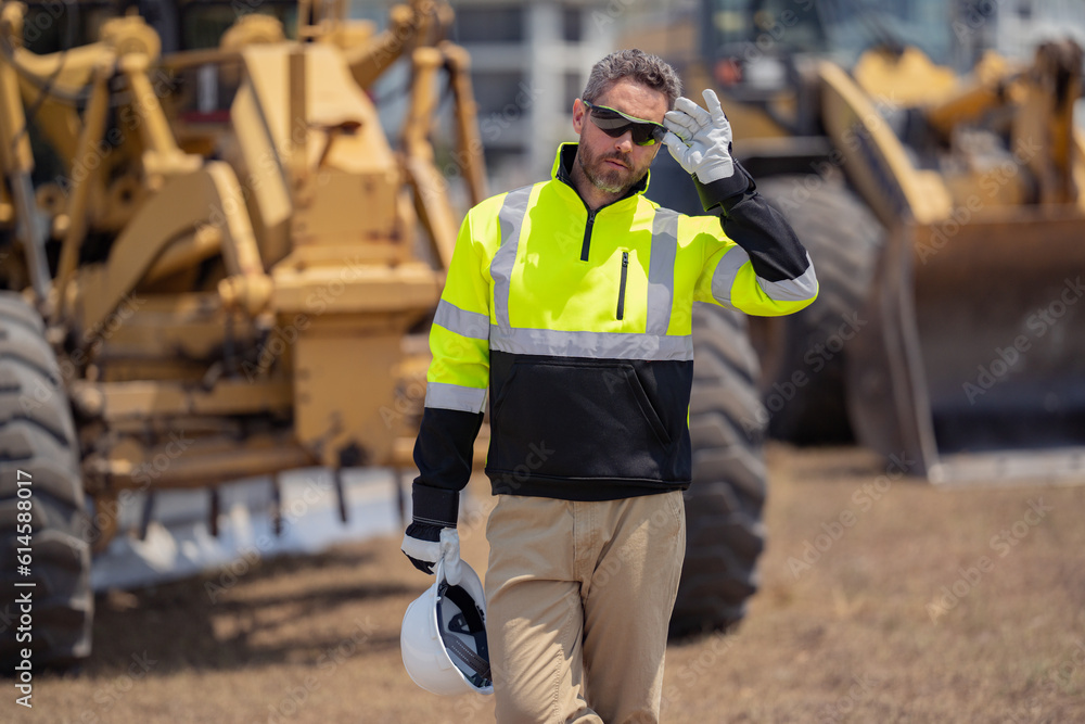 Machinery builder at buildings background. Excavator loader tractor and ...