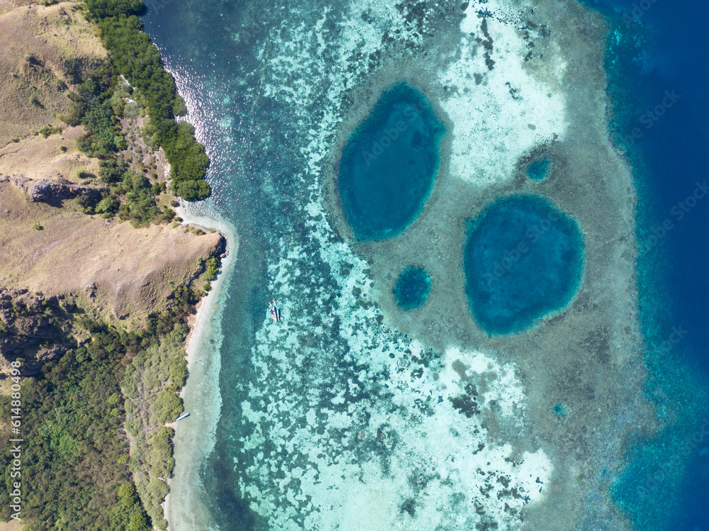 Shallow blue holes are found on a shallow reef flat near the island of ...