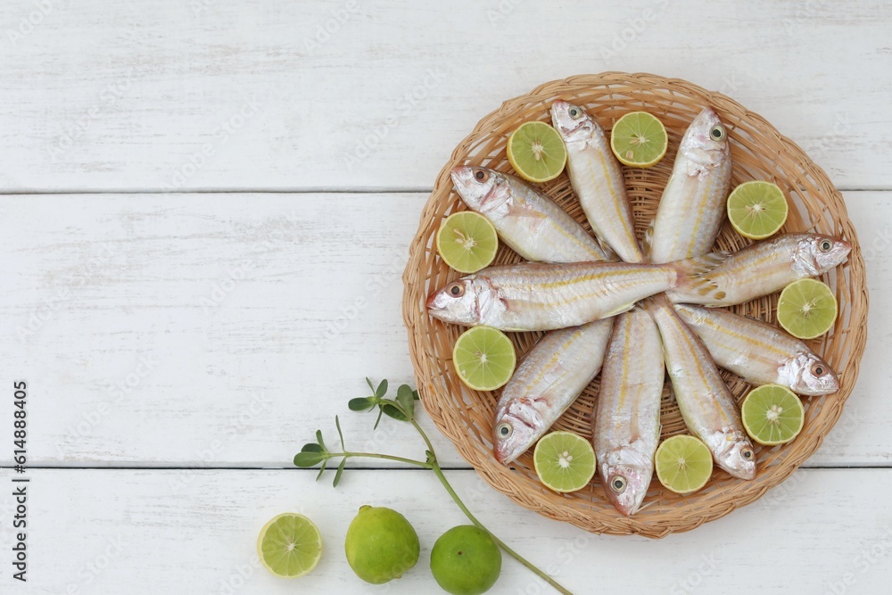 Red mullet, fish on kitchen table, top view, limes, place for text ...