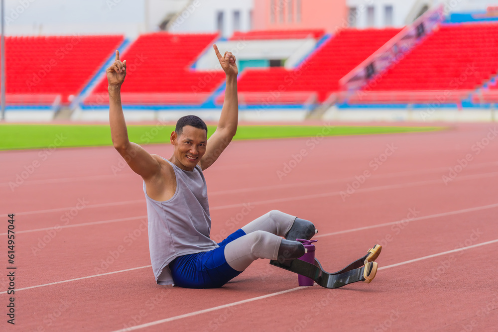 Asian athlete with prosthetics, victorious after speed running, sits on ...