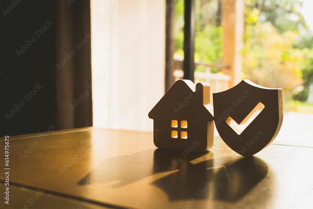 Wooden house model and real estate insurance ideas, and small shield ...