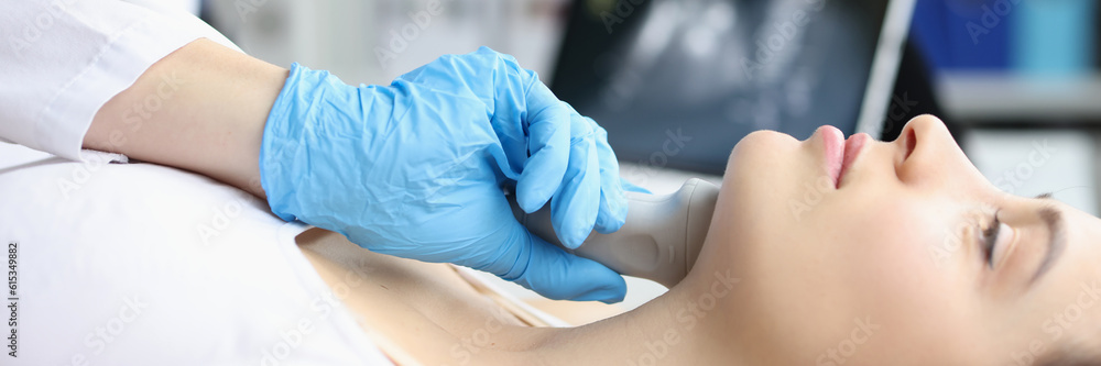 Ultrasound of the soft tissues of face of woman in medical office ...