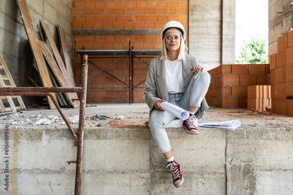 A portrait of female architect leads the construction site, overseeing ...