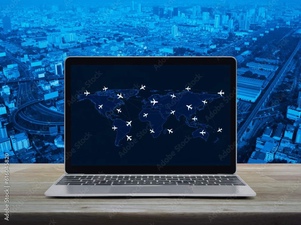 Flight routes airplanes connection and world map on laptop computer ...
