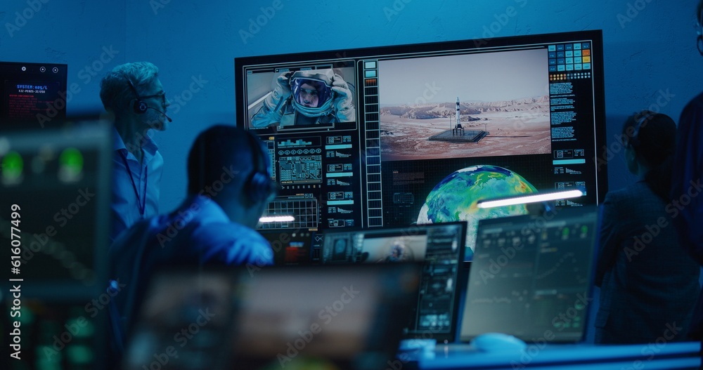 Flight control operators monitor space mission on computers in command ...