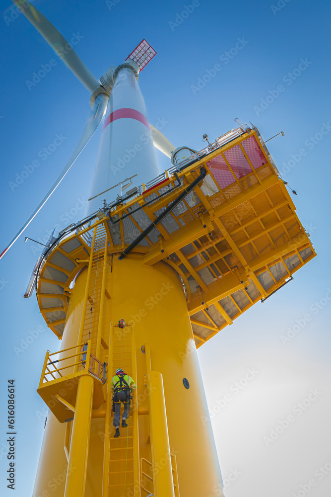 Climbing offshore wind turbine technician Stock Photo | Adobe Stock