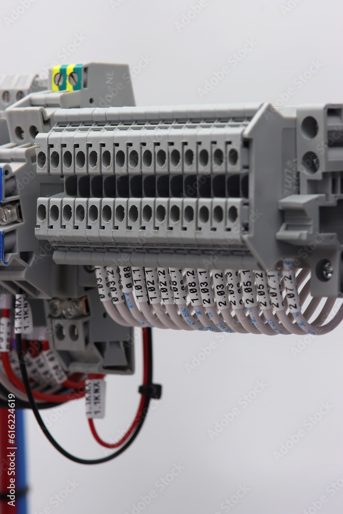 Electrical terminals with connected mounting wires are installed in an ...