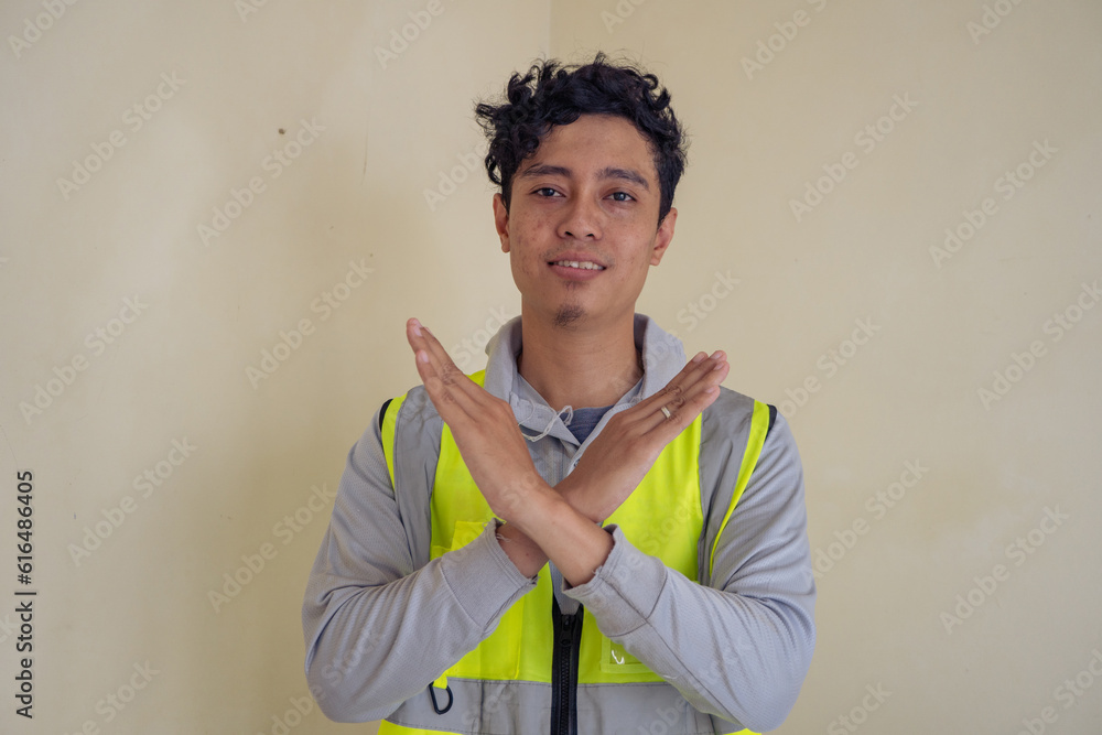 Young curly man wear worker wearpack with disagree pose. The photo is ...