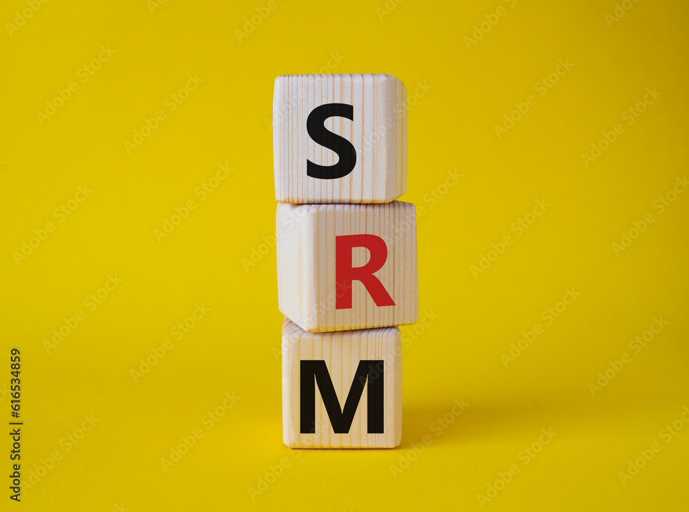 SRM - Sustainability Risk Management symbol. Wooden cubes with word SRM ...