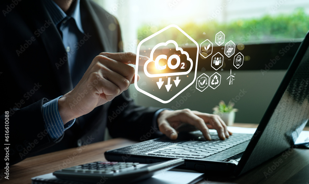 CO2 emission reduction concept, businessman with environmental ...