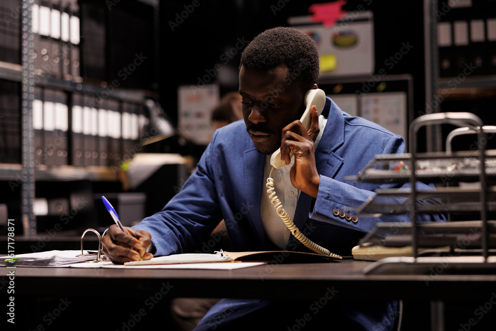 African american police officer talking with remote detective using ...