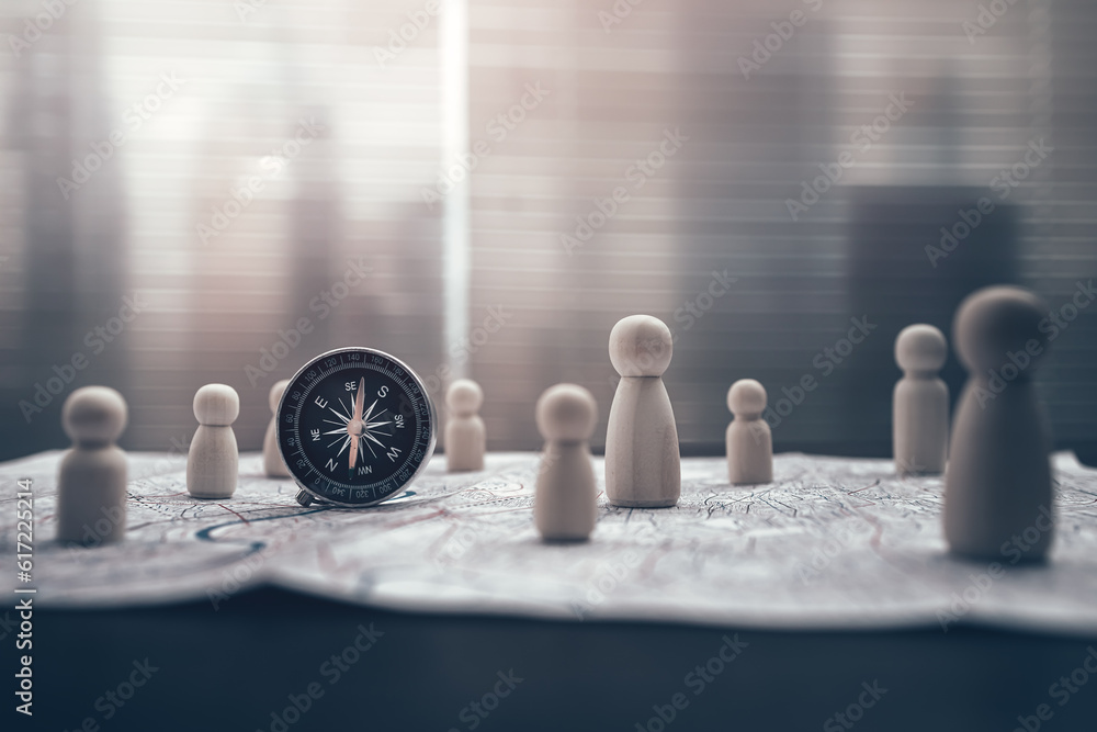 Compass and The wooden doll represents the employee of the company on ...