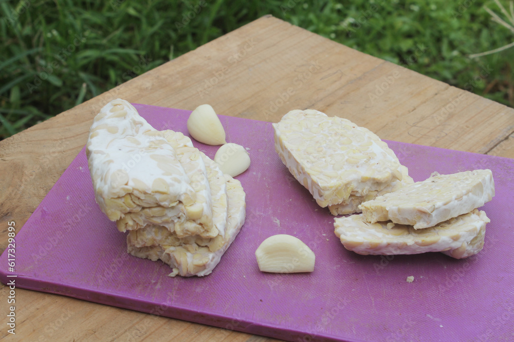 Slice of tempeh or tempe made of fermentation process that binds ...