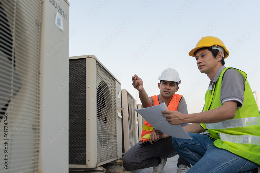 Engineers use blueprint check air condition systems on site. Contractor ...