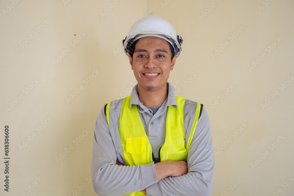 Young construction guys wear the wearpack and helmet with smile pose ...