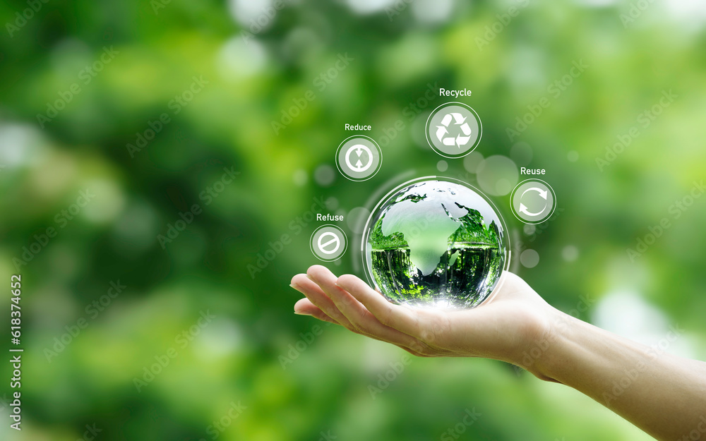 The hands holding the Earth and the icon of reuse reduce recycle and ...
