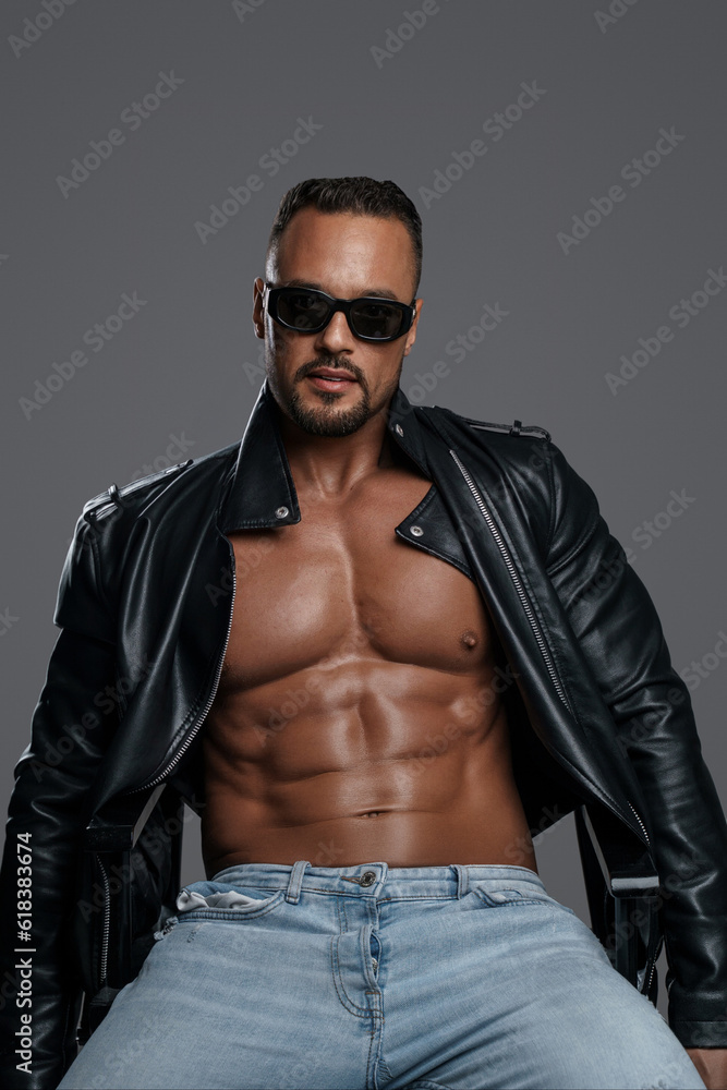 Photo Stock Attractive male model with a muscular shirtless torso poses ...