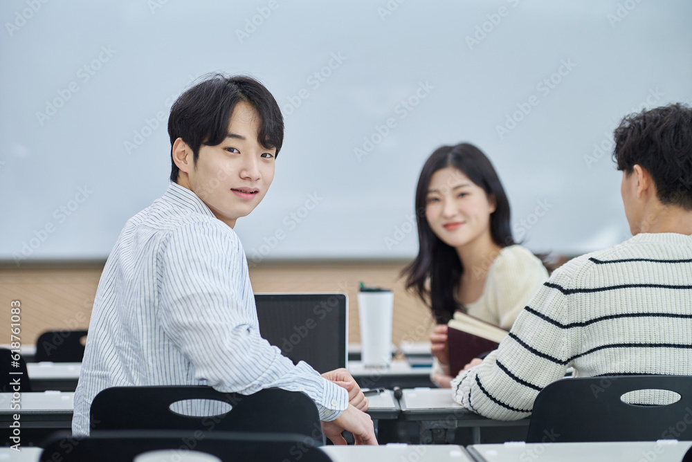 Male and female university students looking backwards talking or ...