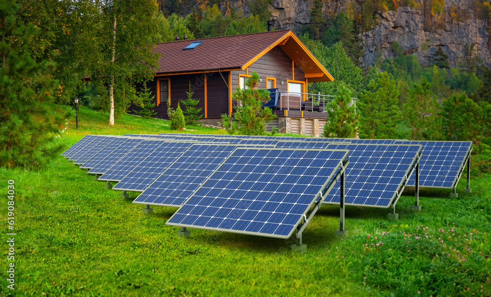 House with solar panels. Cottage among trees. Housing in eco clean ...