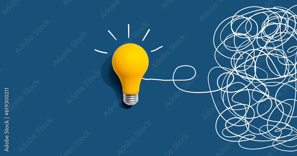 Clarifying complex ideas theme with light bulb - Flat lay Stock Photo ...