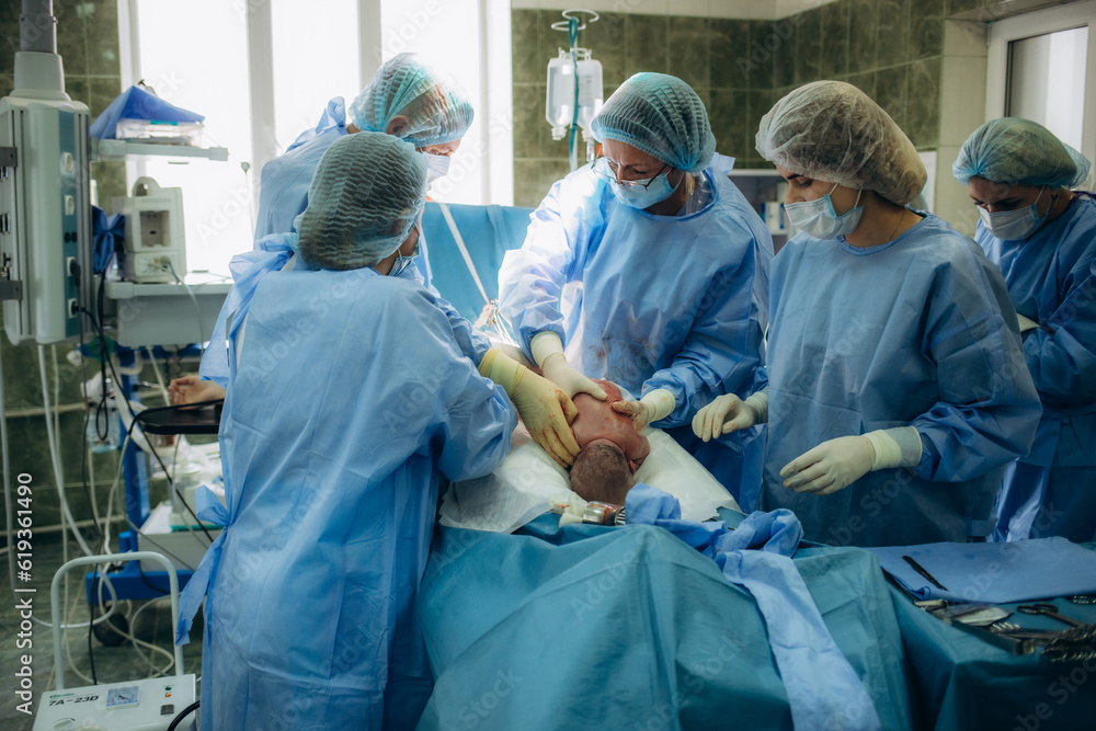 Doctor surgery team in the operating room of abdominal cesarean section ...