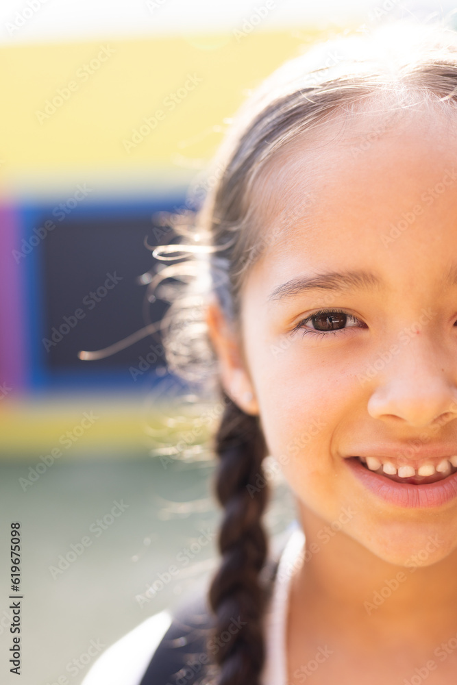 Vertical half face portrait of smiling cauasian elementary schoolgirl ...