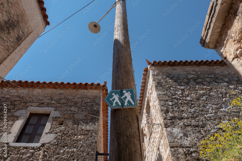 Walker street sign in an old traditional village with stone houses, in ...