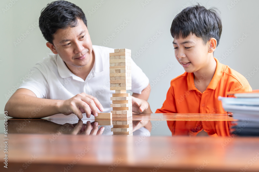Asian father and son playing wood blocks game Carefree kid playing wood ...